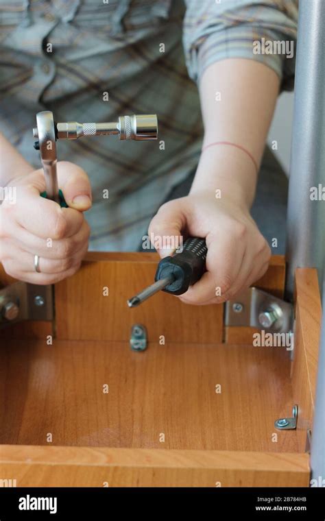 Socket wrench and screwdriver in a hands of workman Stock Photo - Alamy