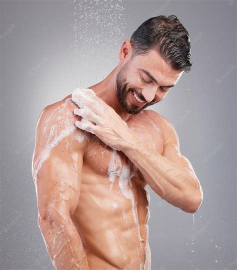 Premium Photo | Shower sponge and man with water in studio on gray background for wellness ...