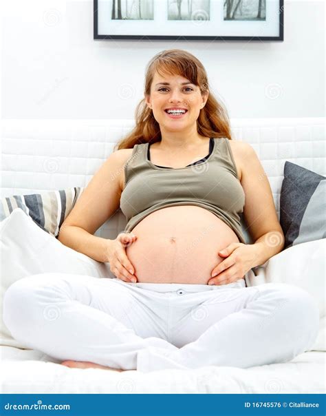 Pregnant Woman Sitting on Sofa and Touching Belly Stock Photo - Image ...