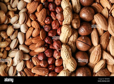Different tasty nuts, closeup Stock Photo - Alamy