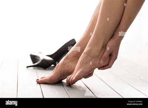 Barefoot Woman with High Heels on Floor Stock Photo - Alamy