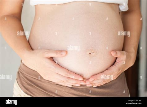 Hand on belly hi-res stock photography and images - Alamy