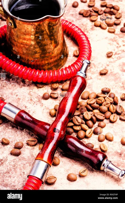 Stylish coffee jezva with coffee and hookah mouthpiece.Arabian shisha ...