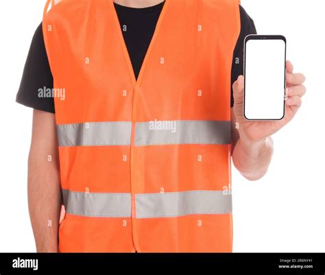 Male industrial engineer in uniform with phone on white background ...