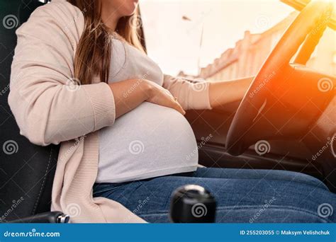 Pregnancy Woman Driving Car. Young Smiling Pregnant Woman Driving Car. Safety Pregnancy Young ...