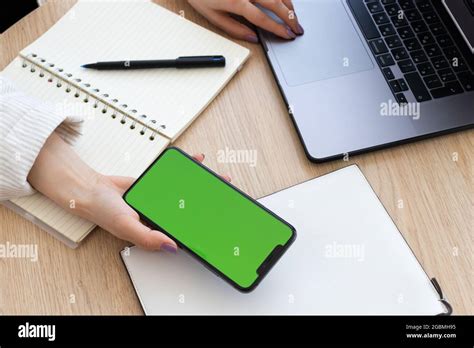 Female hand holding smartphone with chroma key screen Stock Photo - Alamy