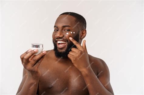 Free Photo | African handsome man applying cream on his face mans skin ...