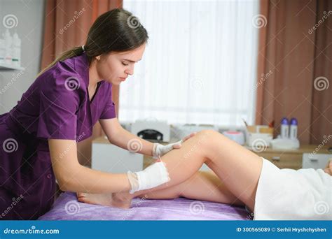 Beautician Waxing Woman Legs in a Spa Salon Stock Image - Image of ...