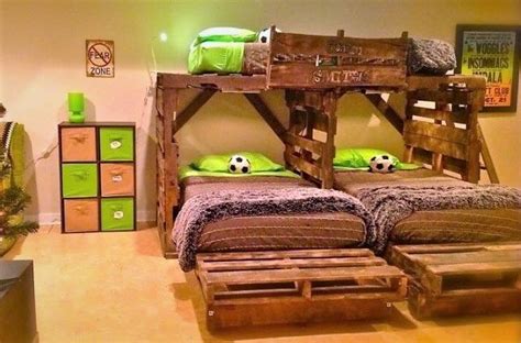 bunk beds made out of wooden pallets in a room with green pillows and ...