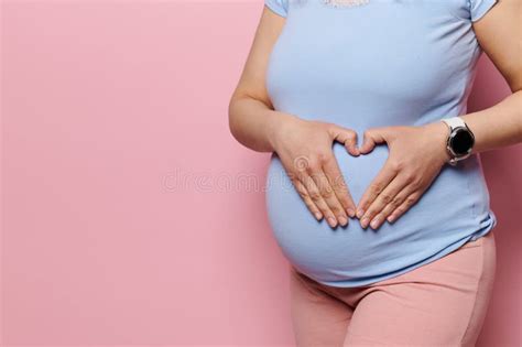 Close-up Pregnant Belly with Stretch Marks of Gravid Woman Holding Bouquet of Flowers Over Big ...