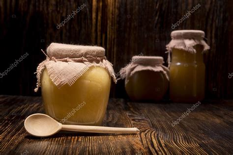 Три банки меда и ложки на деревянном фоне: стоковая фотография © Vladi ...