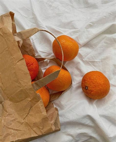 Four Oranges in a Brown Paper Bag