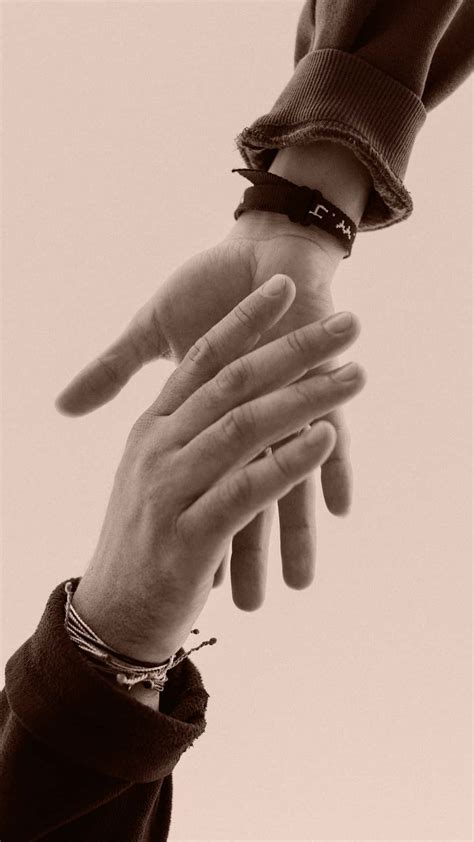 Download Gentle Handshake With Bracelets Wallpaper | Wallpapers.com
