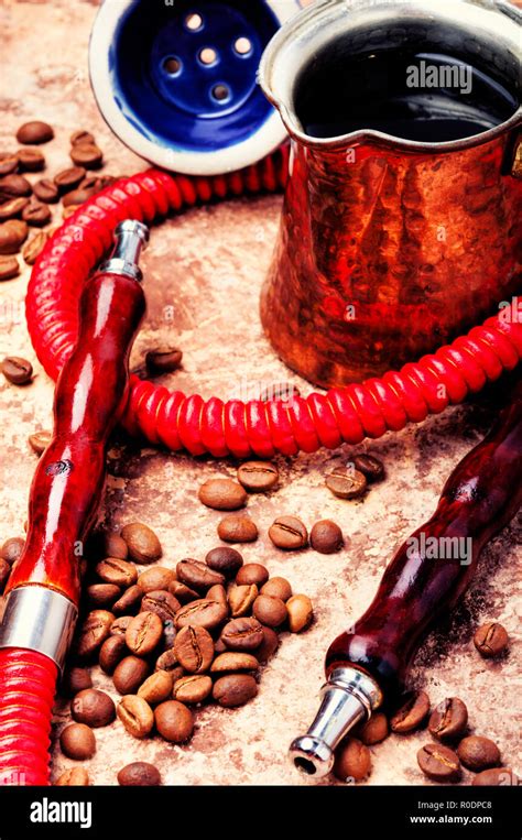 Stylish coffee jezva with coffee and hookah mouthpiece.Arabian shisha ...