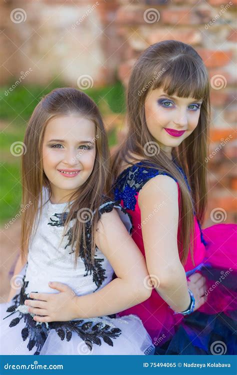 Fashion Photo of Two Beautiful Girls on a Background of Brick Ru Stock ...