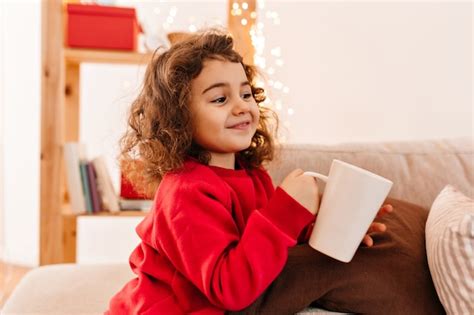 Free Photo | Joyful little kid drinking tea. lovely curly child holding ...