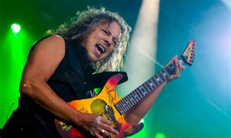 a man playing an electric guitar on stage