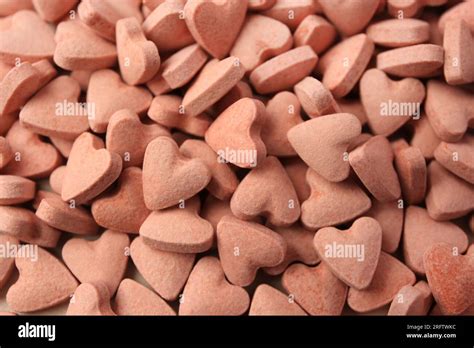 Heart shaped vitamins for pets as background, closeup Stock Photo - Alamy