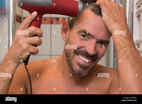 man blow drying Stock Photo - Alamy
