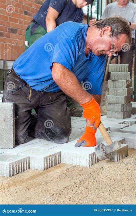 Erbauer, Der Pflastersteine Mit Seinem Team Legt Stockbild - Bild von ...